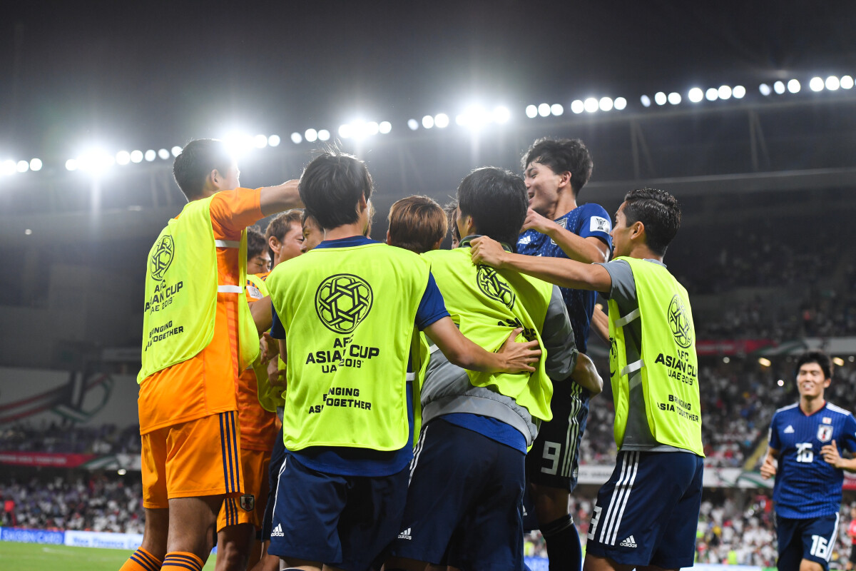 Japan celebrate after defeating IR Iran 3-0 at the Hazza bin Zayed Stadium.